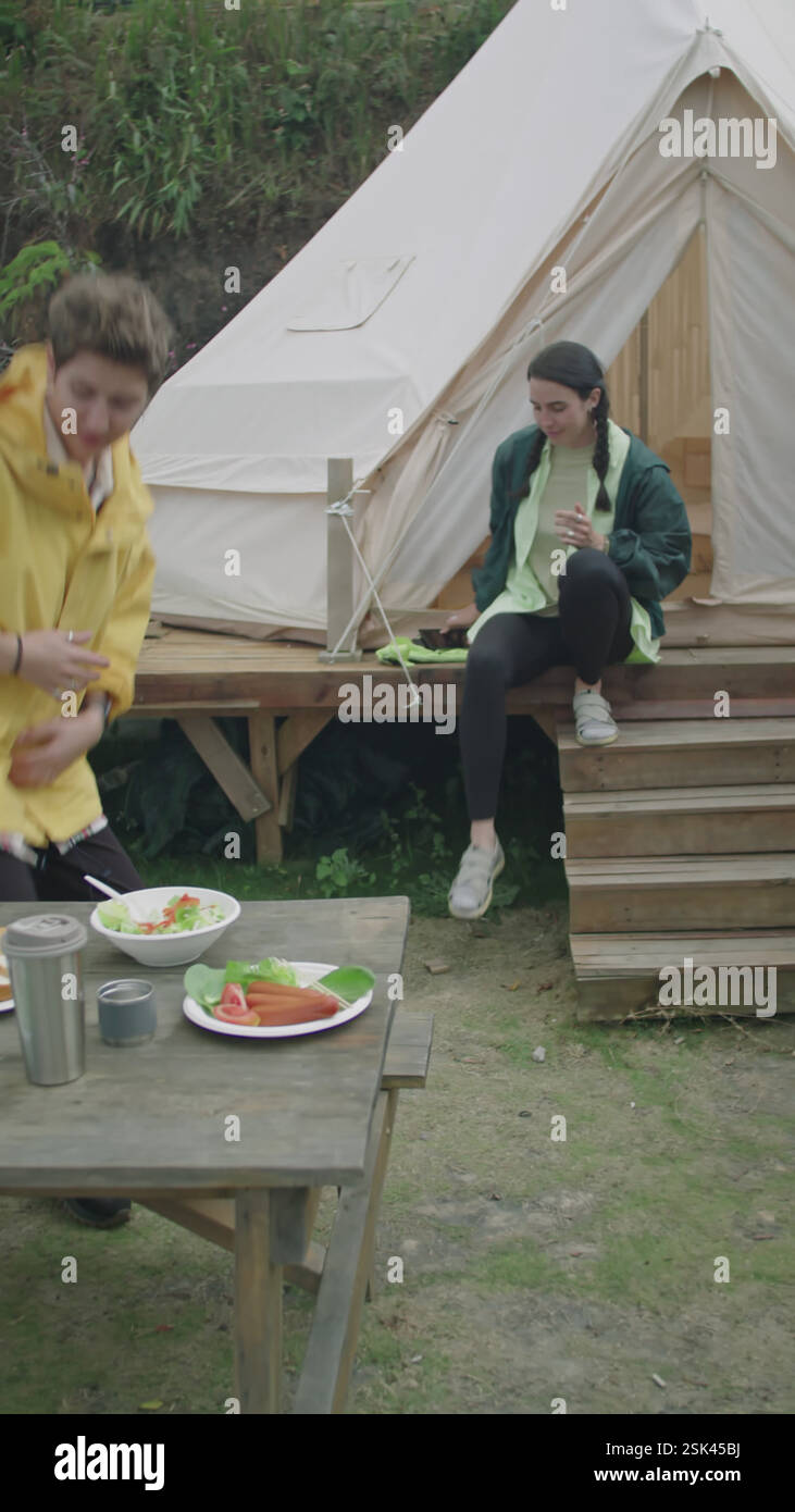 Friends Serving Dinner on Wooden Table while Glamping Stock Video ...
