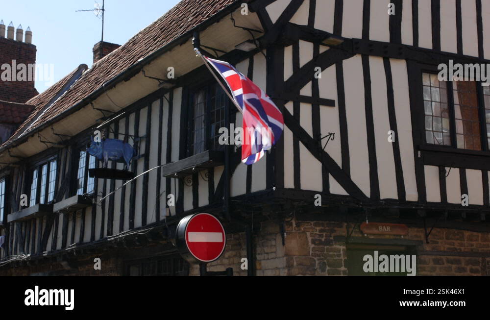 An Old British Tudor Pub With Bar Entrance Door and Union Jack Flag ...