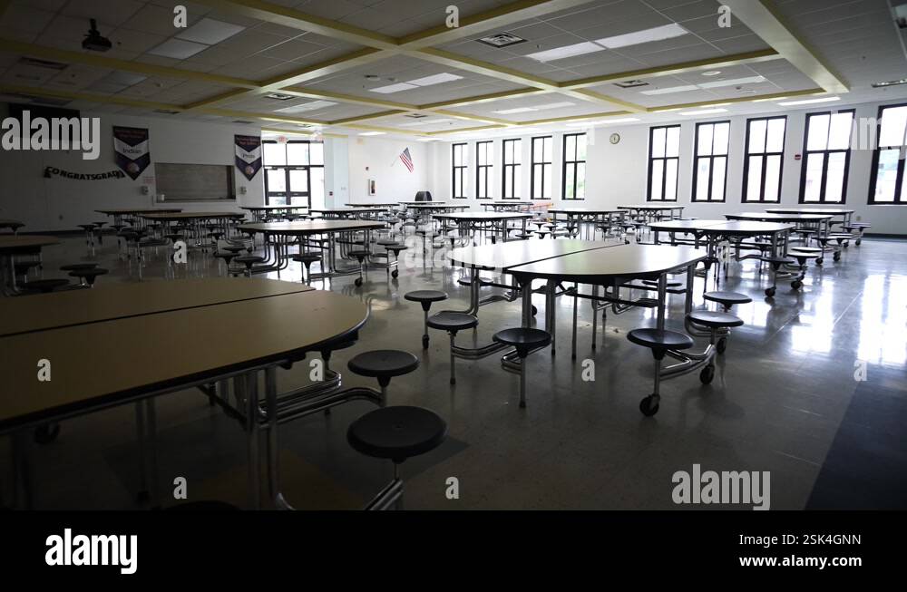 Trucking view to right showing dark and empty school cafeteria with ...