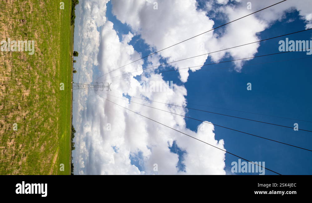 Symmetrical electrical pylons with natural powerful cloud formations ...