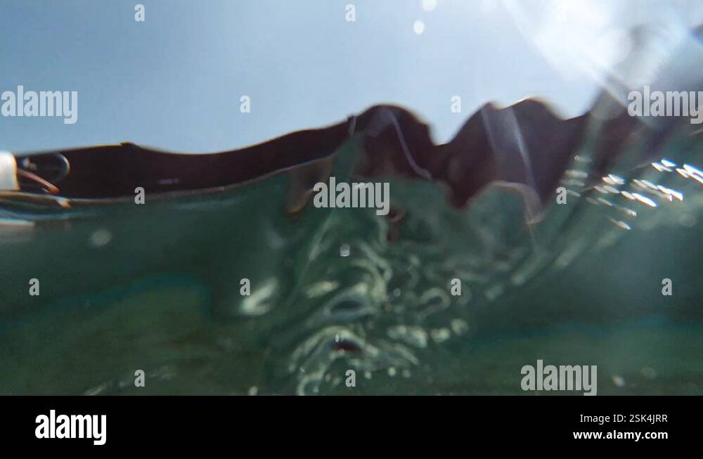 Water Gently Rolling Over Camera Lens in Swimming Pool with Sun Flare ...