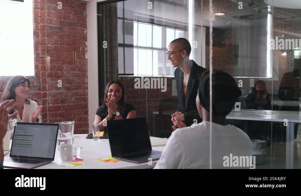 Successful business woman receiving an applause for her work in a team ...