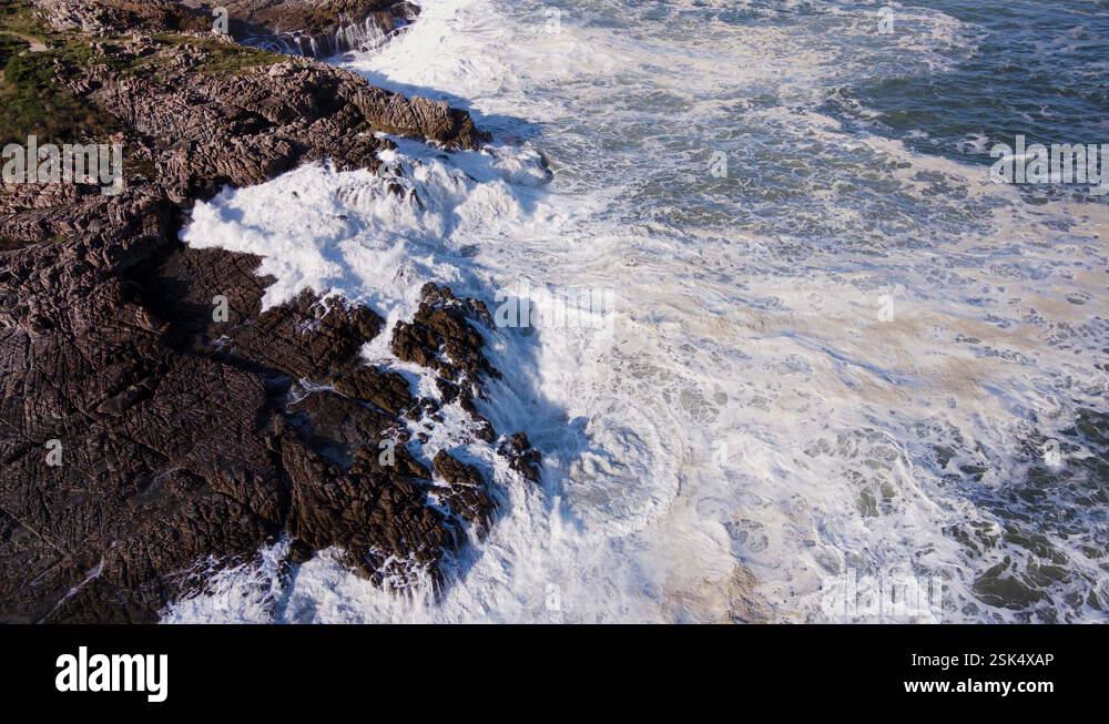 Frothing waves crash into rugged rocky coastline of Hermanus at Sievers ...