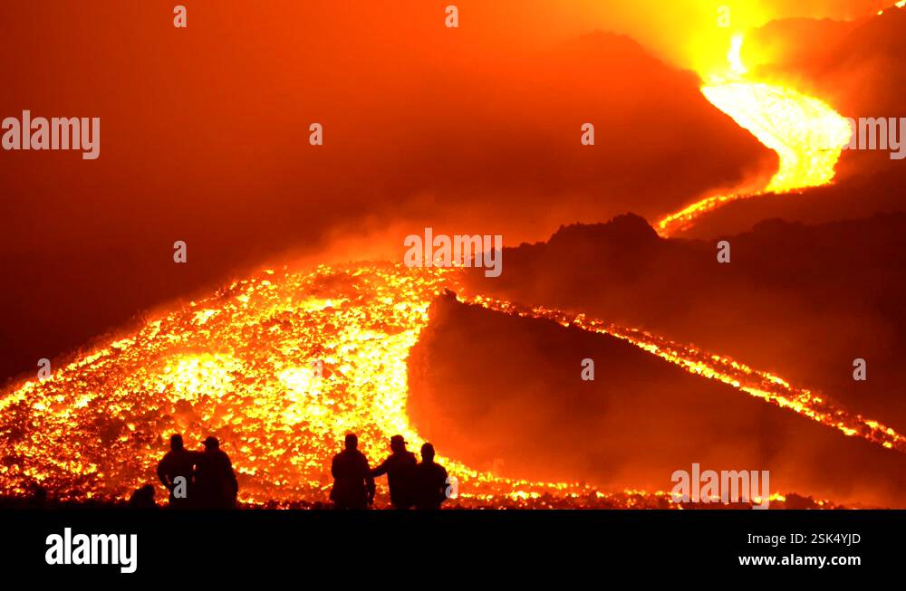 People standing in front of the erupting Volcan de Pacaya Volcano in ...