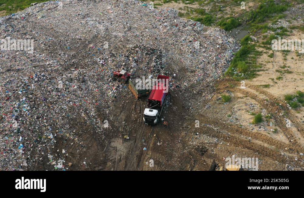 Garbage truck with tractor and bulldozer on the landfill site pile ...