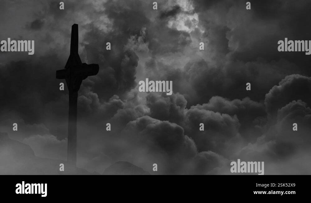 silhouette of a cross on the rocks against a background of storm clouds ...