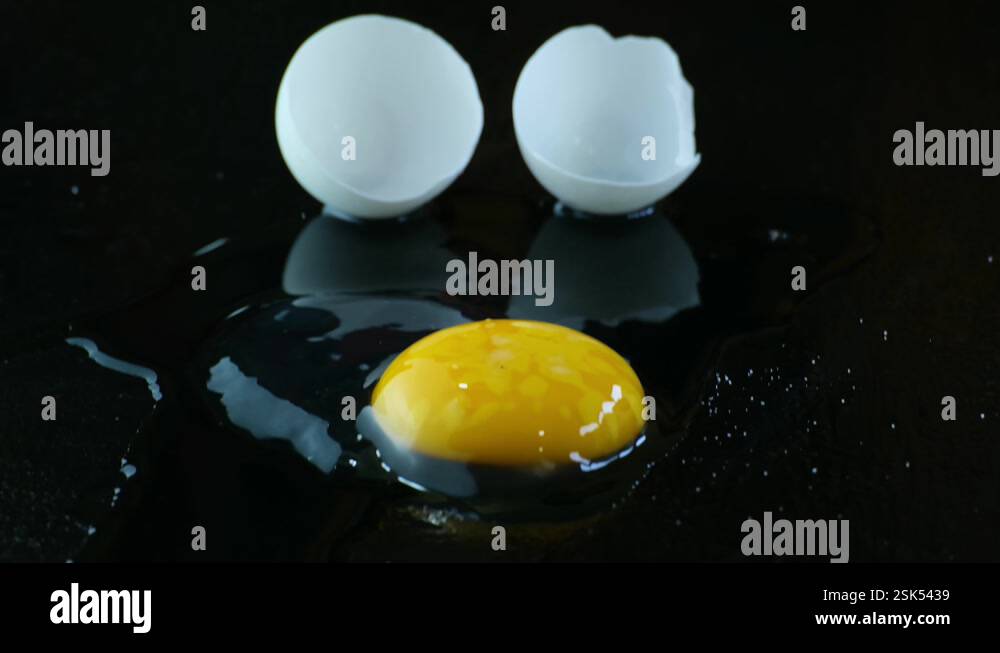 Tilt down to reveal and perfectly cracked egg with the raw yoke and egg ...