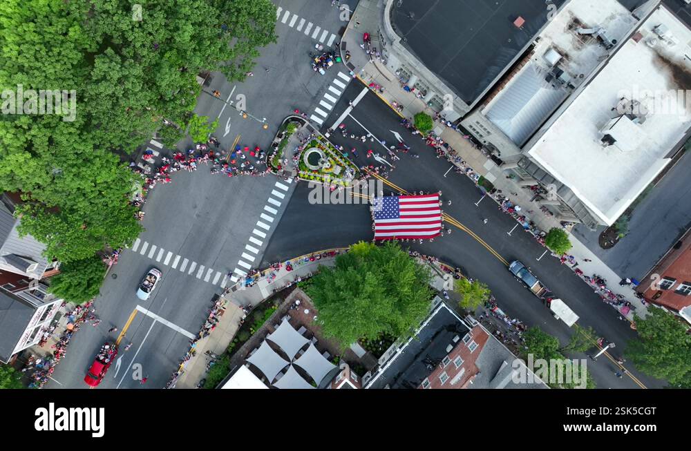 The crowd at an intersection as floats and a giant star-spangled banner ...