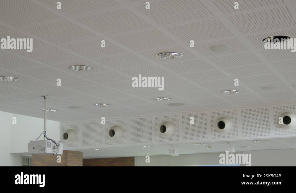 White ceiling with installed lamps, air inlets - ventilation. Digital ...