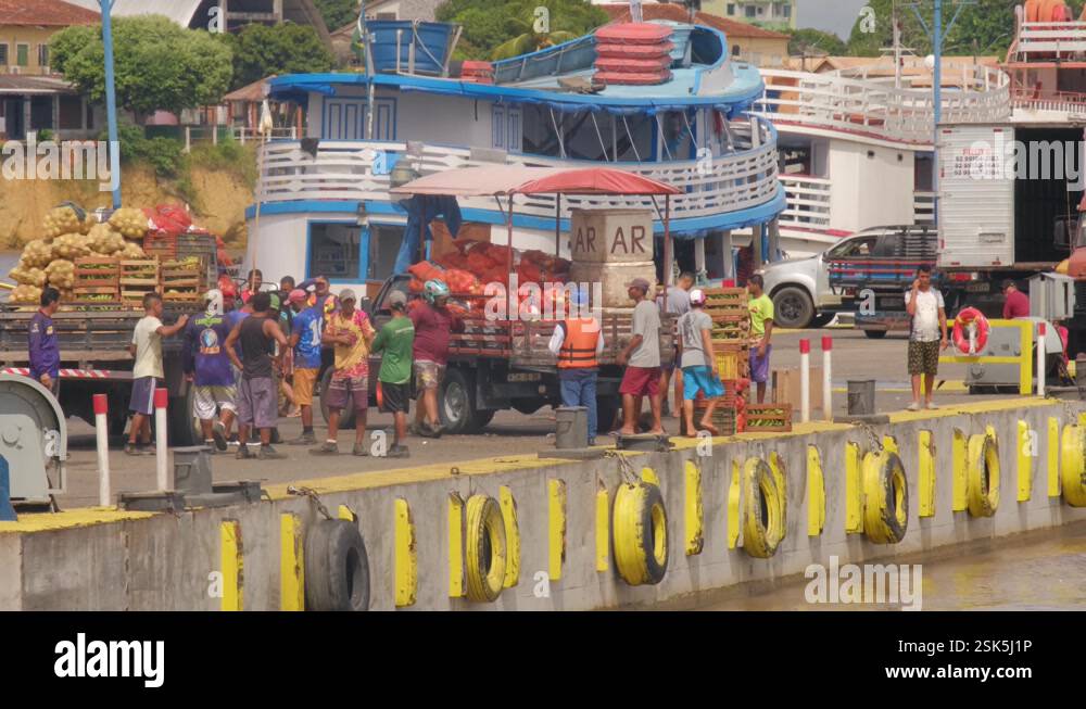 worker at the port of the amazon rainforest hub unload cargo boat Stock ...