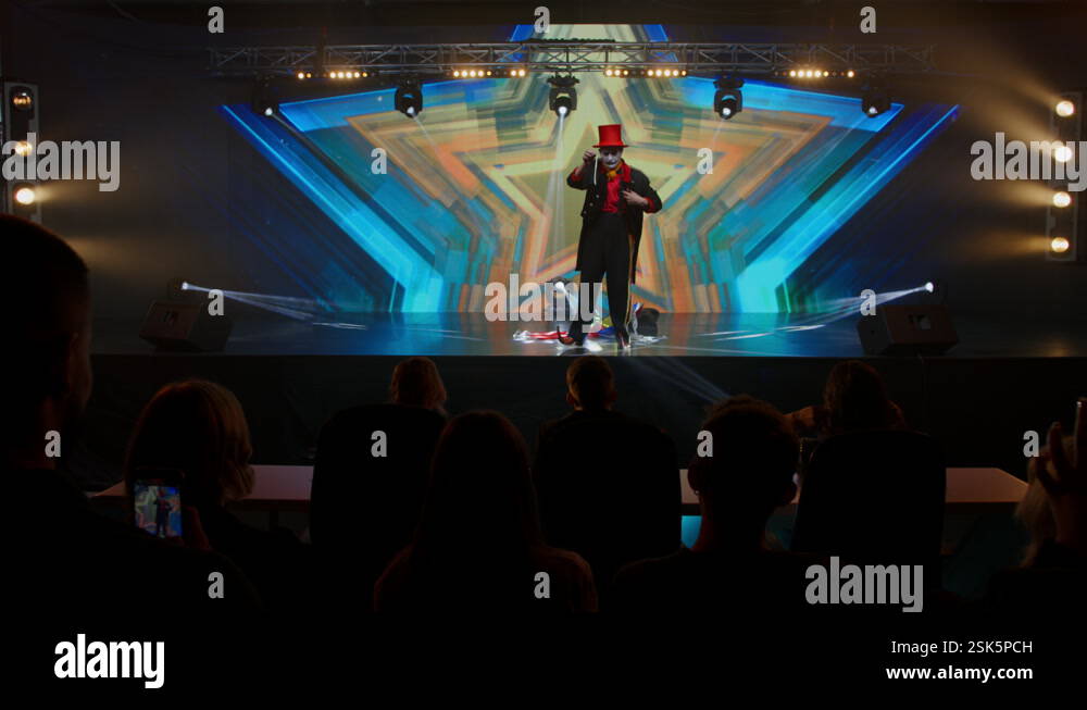 Creepy clown mime showing magic tricks on stage during TV talent show ...
