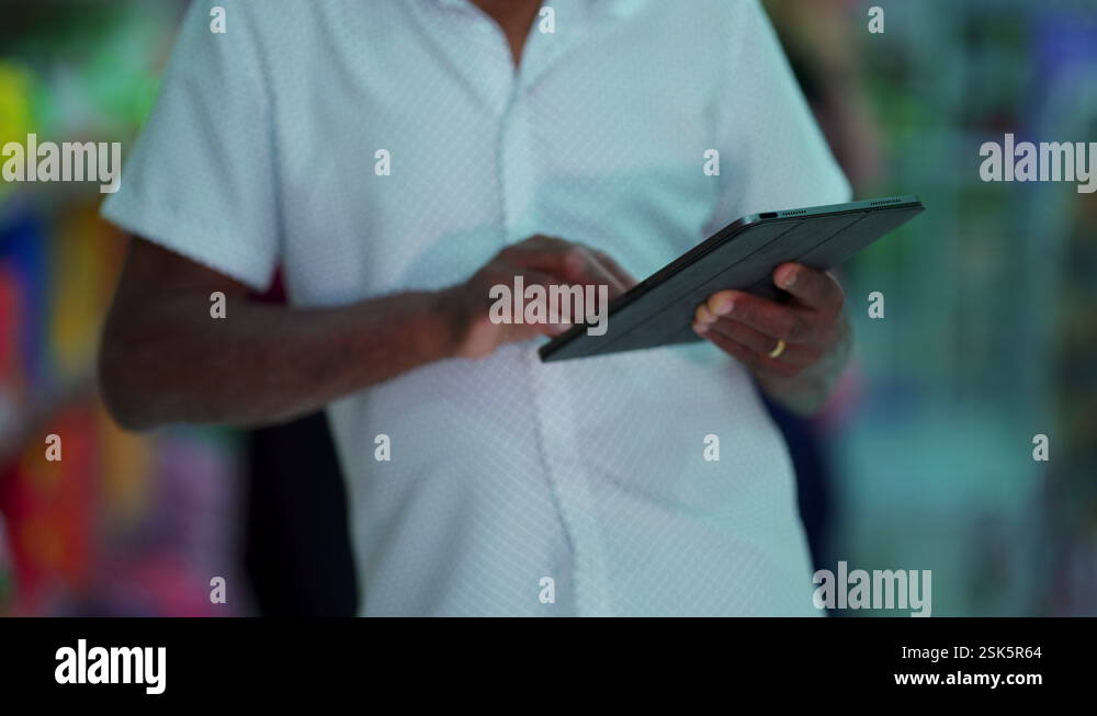 Close-up of a senior black man hands holding tablet device. Elderly ...