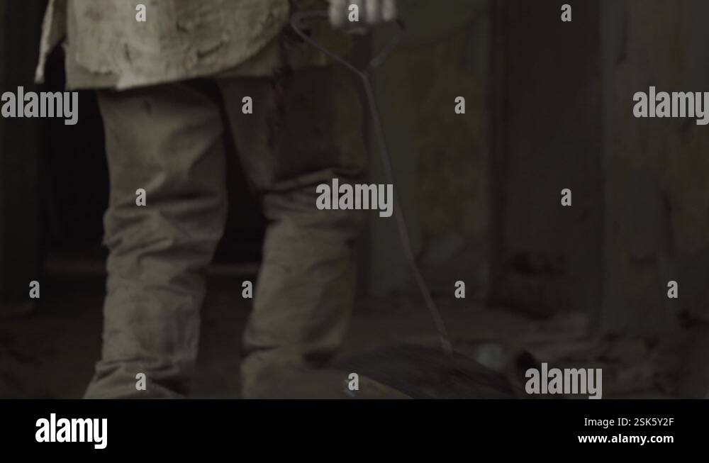 Ghost of maniac with cage on his head dragging dead body down corridor ...