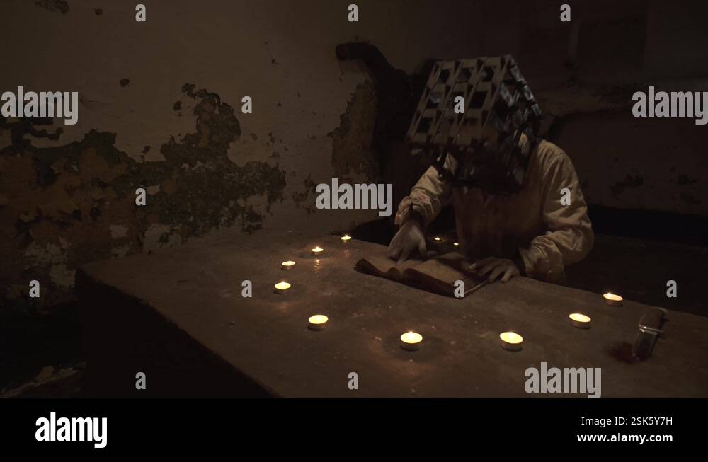 Ghost with cage on his head reading spells next to crucified body in ...