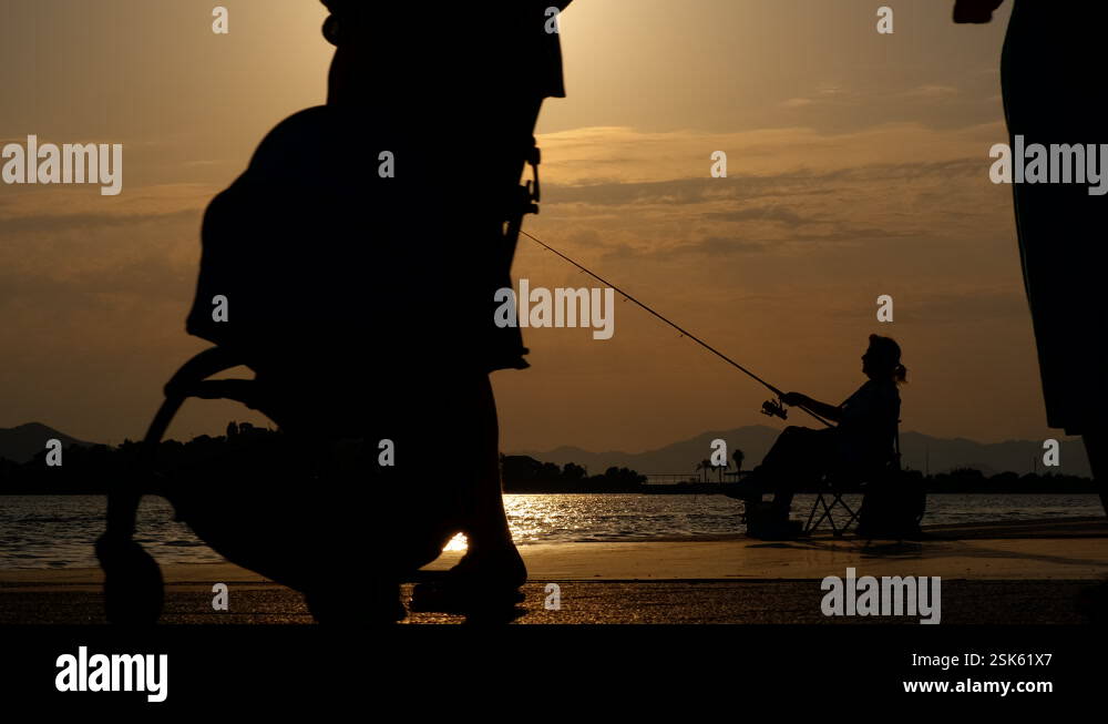 Fishing relaxation on nightfall beach Stock Video Footage - Alamy