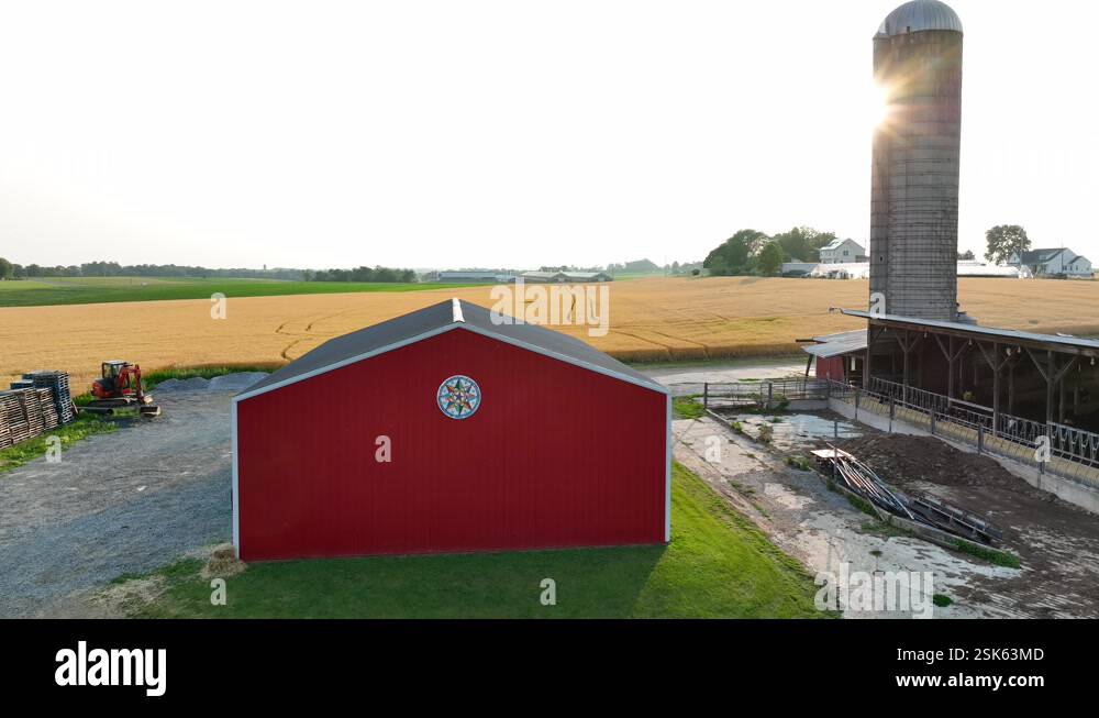 Red barn with Hex sign during beautiful summer sunset. Aerial ...
