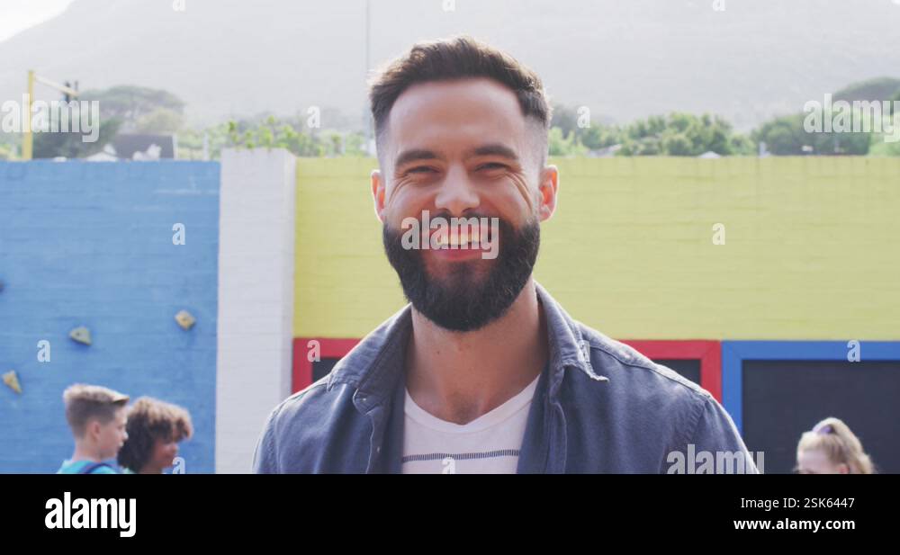Portrait of happy caucasian male teacher with happy diverse group of ...