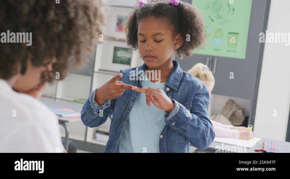 Video of diverse schoolboy and schoolgirl practicing sign language in classroom Stock Video ...