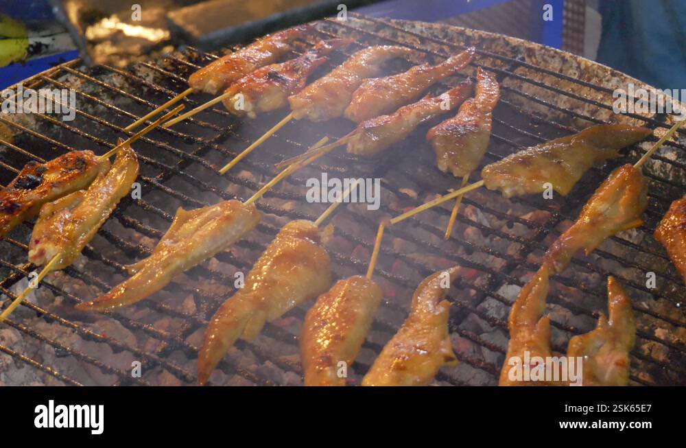 Asian thailand night market street food booth grilled chicken wings ...