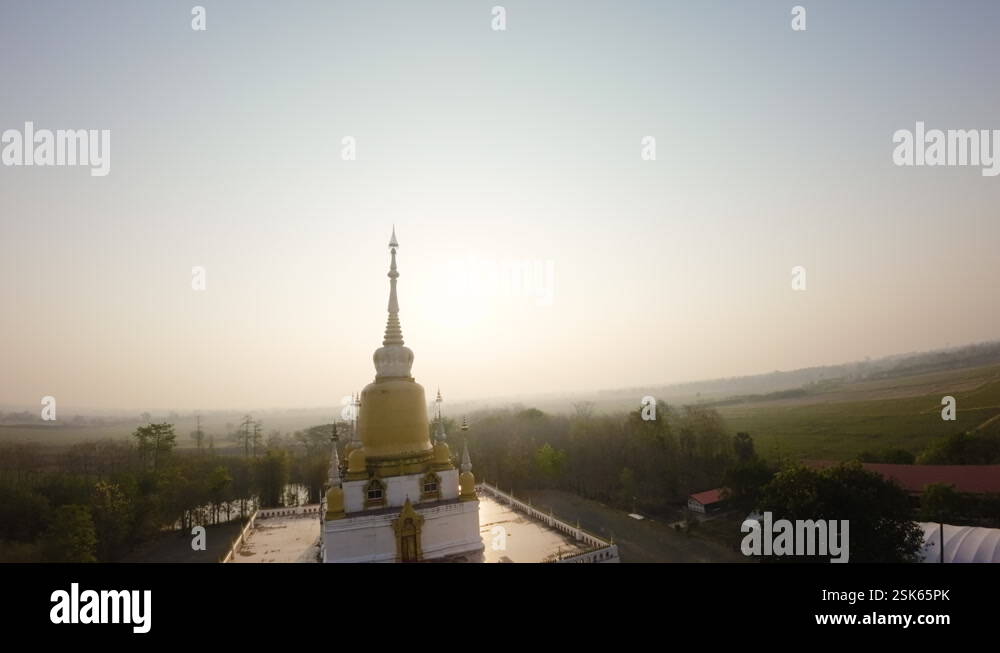 FPV shot around a golden-painted church in the countryside of Bangkok ...