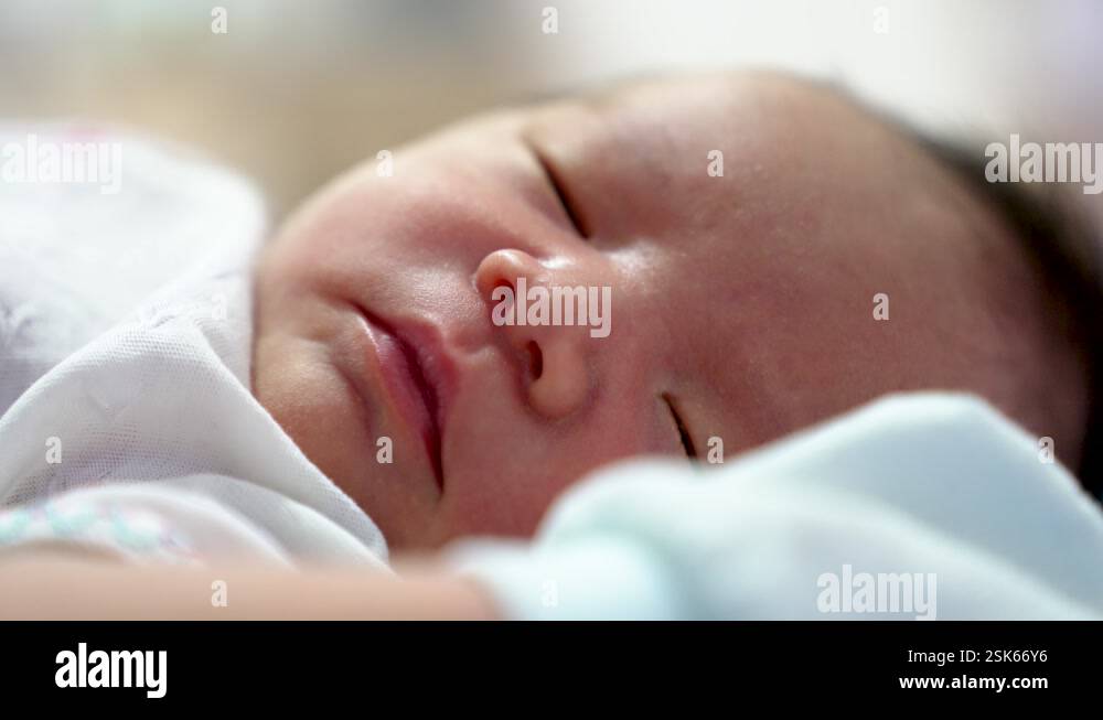 Newborn baby infant boy asian sleeping try to open eyes and peep and ...