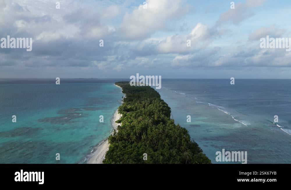 Vertical aerial along Dhigurah island in the Maldives, a long sandbank ...