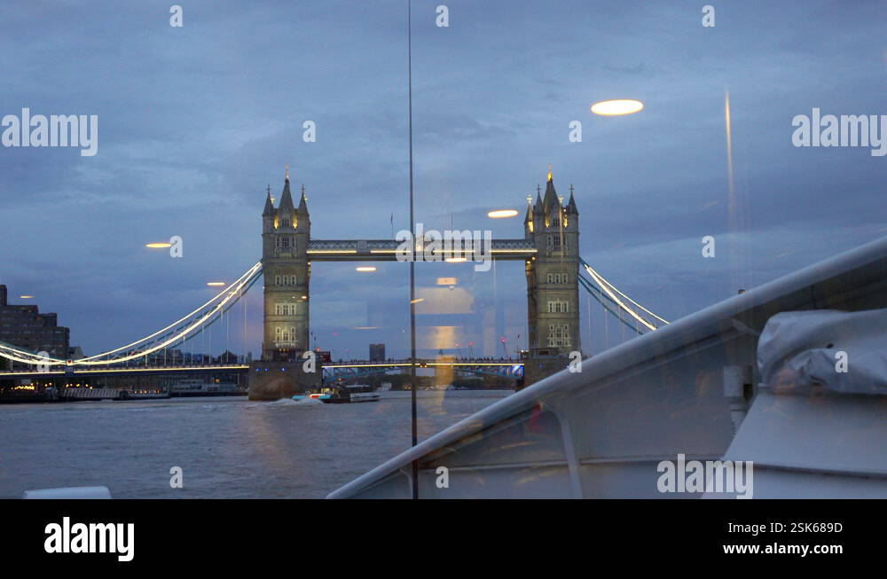 Shot of the London Bridge from inside a boat at the Thames River during ...