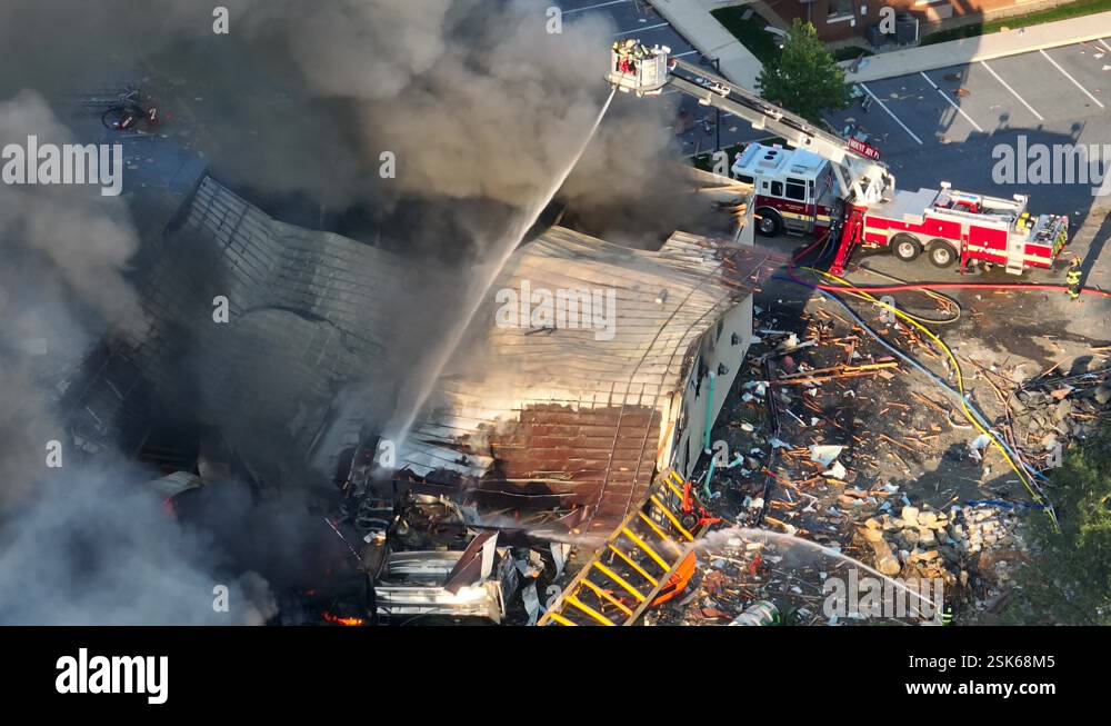 Firefighter on ladder Extinguish fire after gas explosion during ...