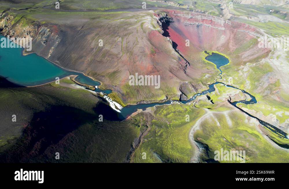 Aerial view of a sulphurous green lake with craters and lakes in ...