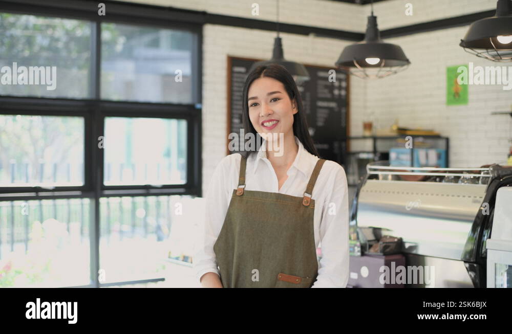Barista concept of 4k Resolution. Asian woman greeting customers in a ...