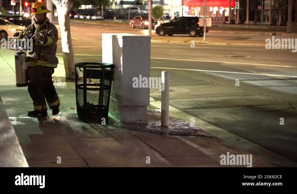 firefighter puts out trash can fire Stock Video Footage - Alamy