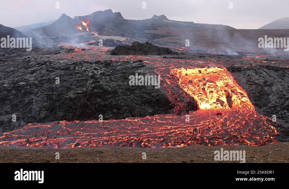 erupting volcano, volcanic lava melting into rock Stock Video Footage ...