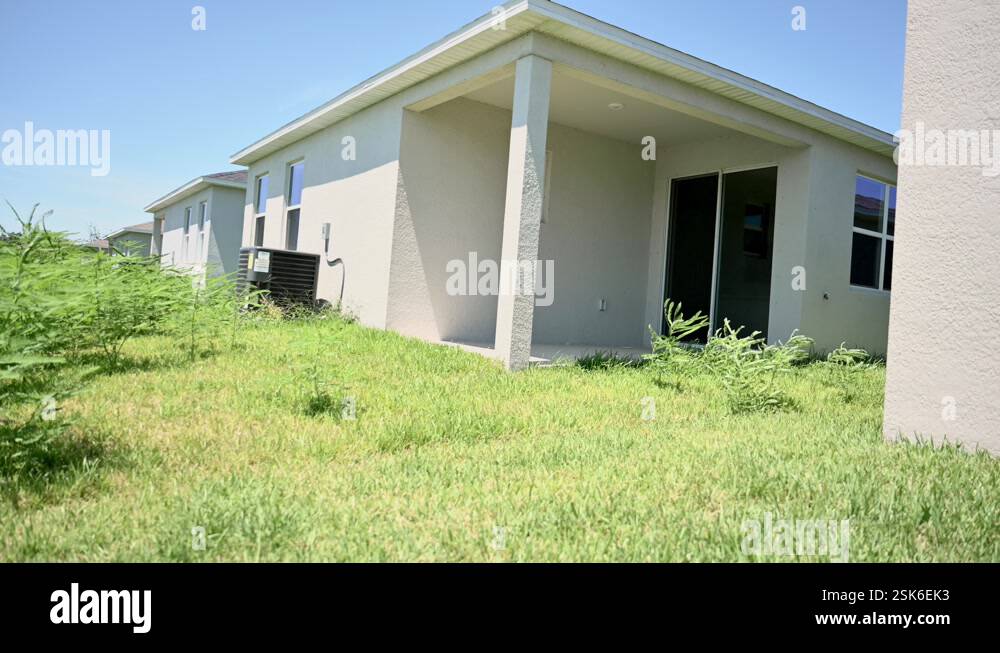 unsold housing in South Florida, abandoned yard, unmaintained despite ...
