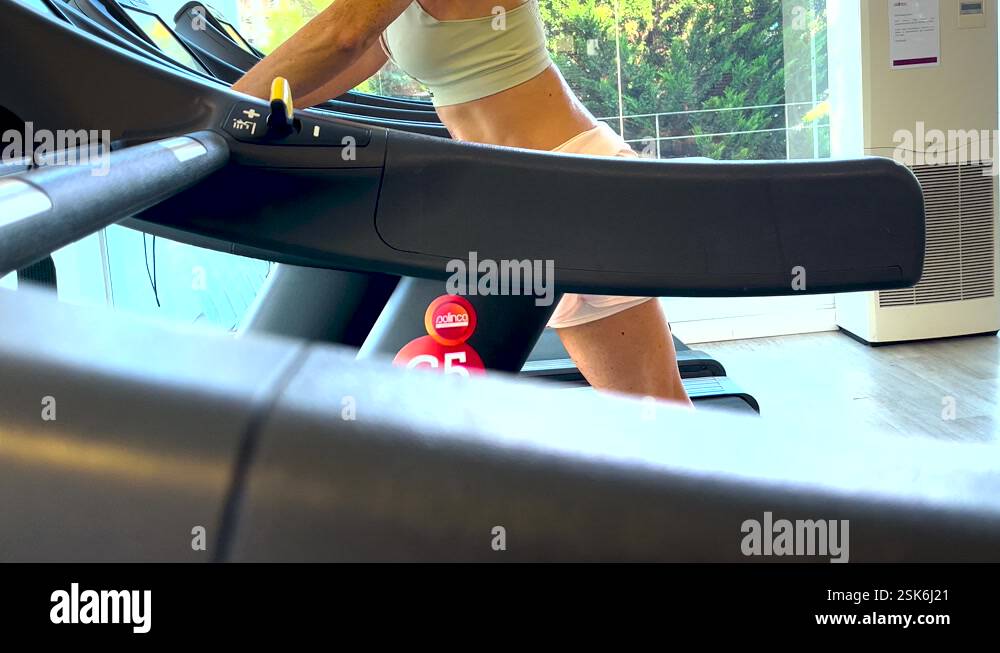 Focused and fit woman stretching on treadmill in gym, slow motion Stock ...