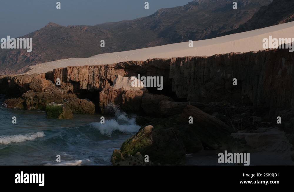 Rugged Cliffs With White Sand Dunes In Delisha Beach, Socotra Island ...