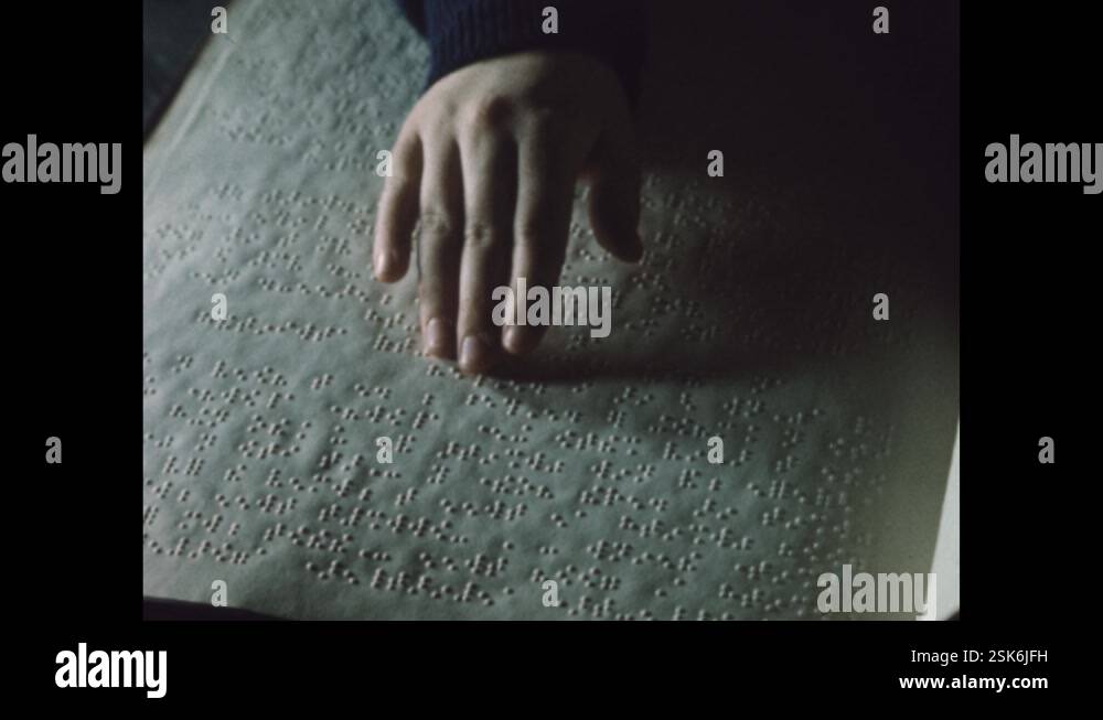 1960s: Person runs hand over braille words on page Stock Video Footage ...