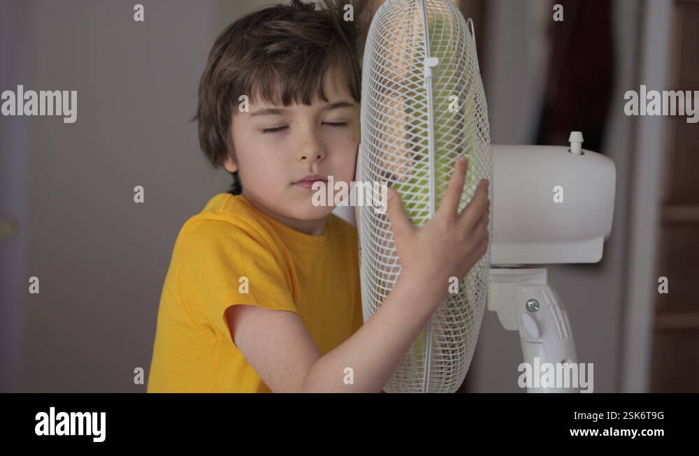 Child Enjoying Cool Wind From Electric Fan at Home at Summer Vacation ...