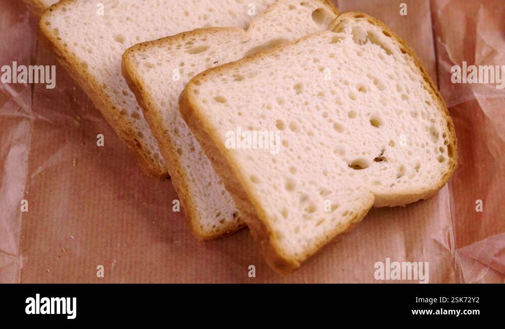 Sliced loaf of white gluten free bread. Falling slice in slow motion ...