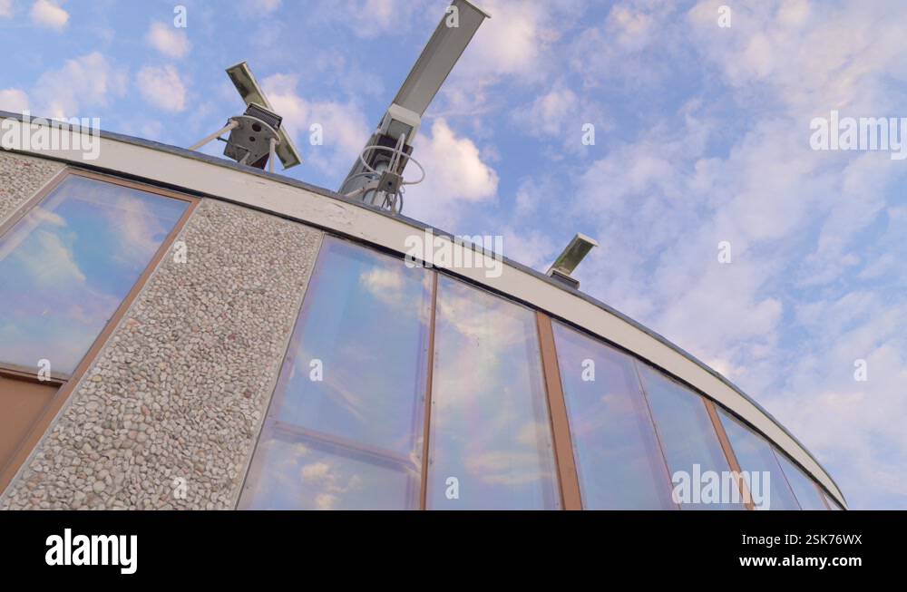 Low angle showing radar equipment on roof of curved structure in slow ...