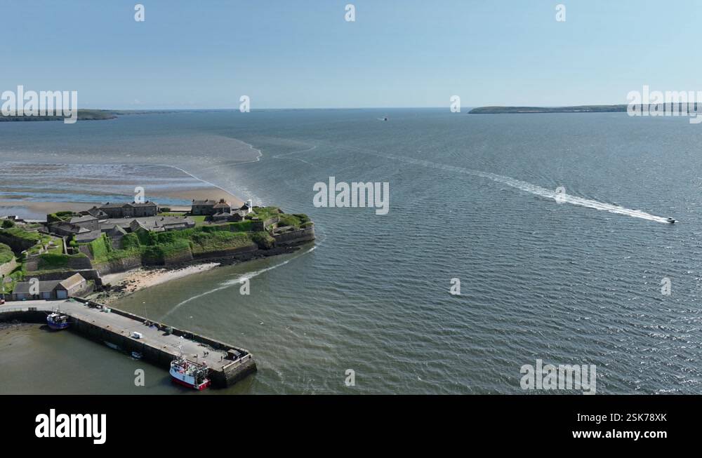 Boat passing Duncannon Fort with the exit of the Waterford Estuary into ...