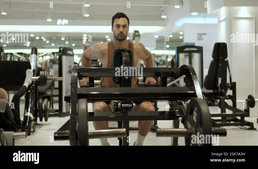 Fit Sporty Man Exercises in Dips Lower Chest Press Machine at Modern ...