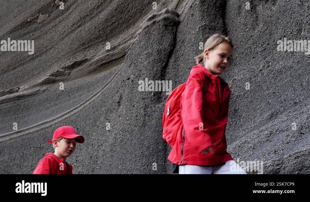 Caucasoid teenagers girls and boys are traveling in the mountains ...