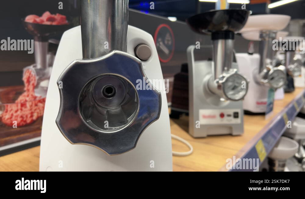 New electric meat grinders are lined up on the shelves of a home ...