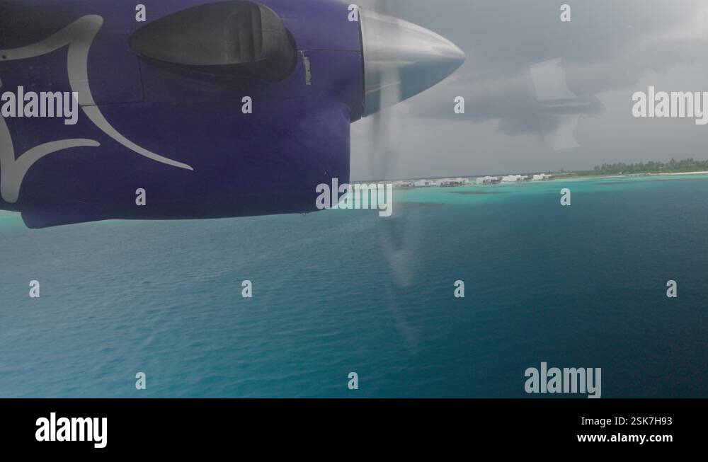 Seaplane takeoff from blue tropical water near Maldives island, window ...