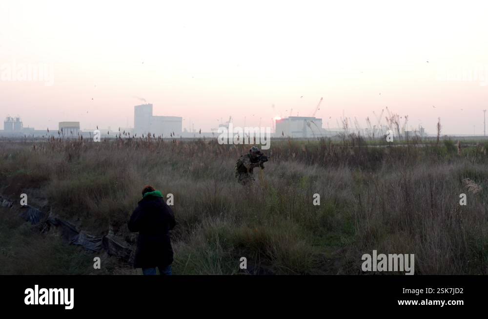 Fully equipped and armed soldiers hiding and searching during combat ...