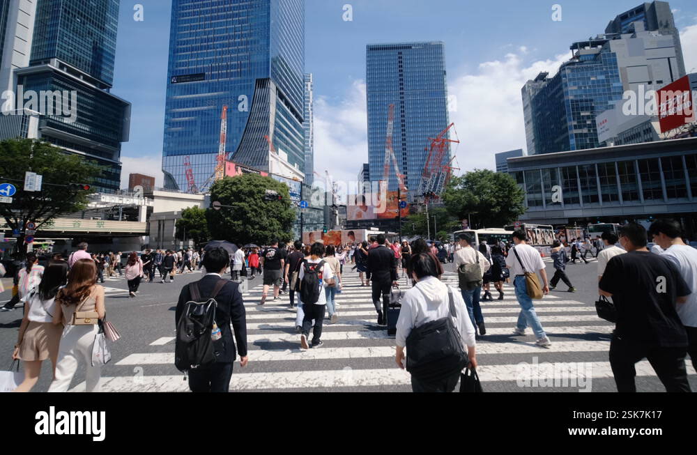 People walk at Shibuya scramble crossing. Crowd of people at the street ...