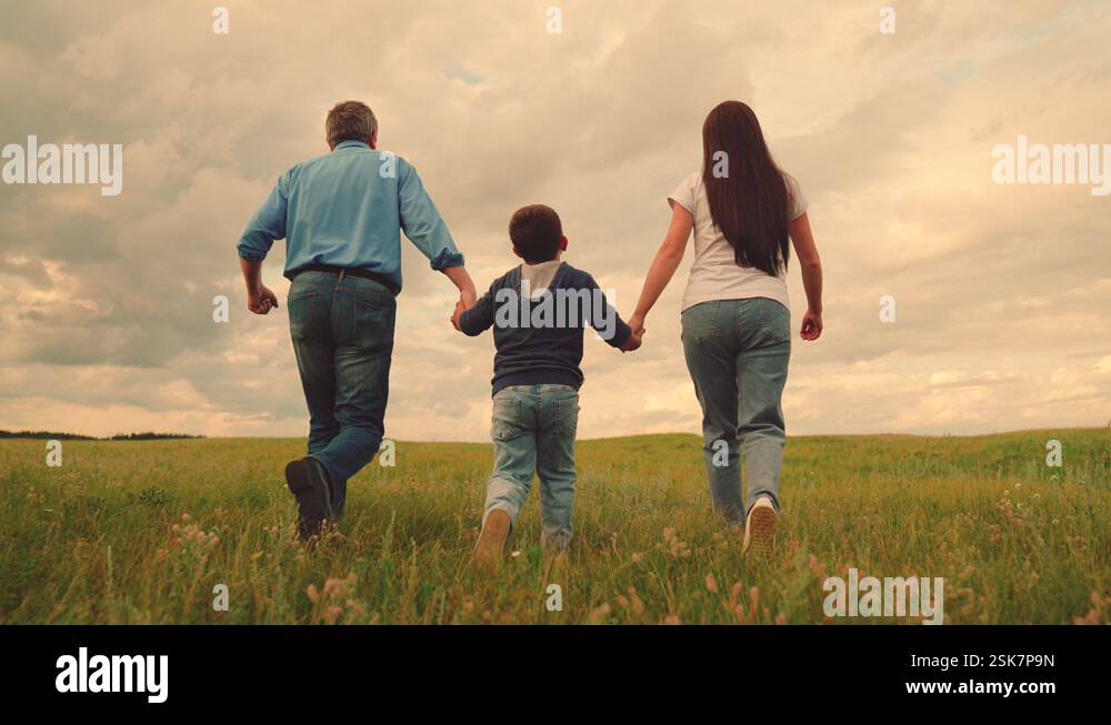 Happy family runs in park on green grass. Family game, teamwork. Dad ...