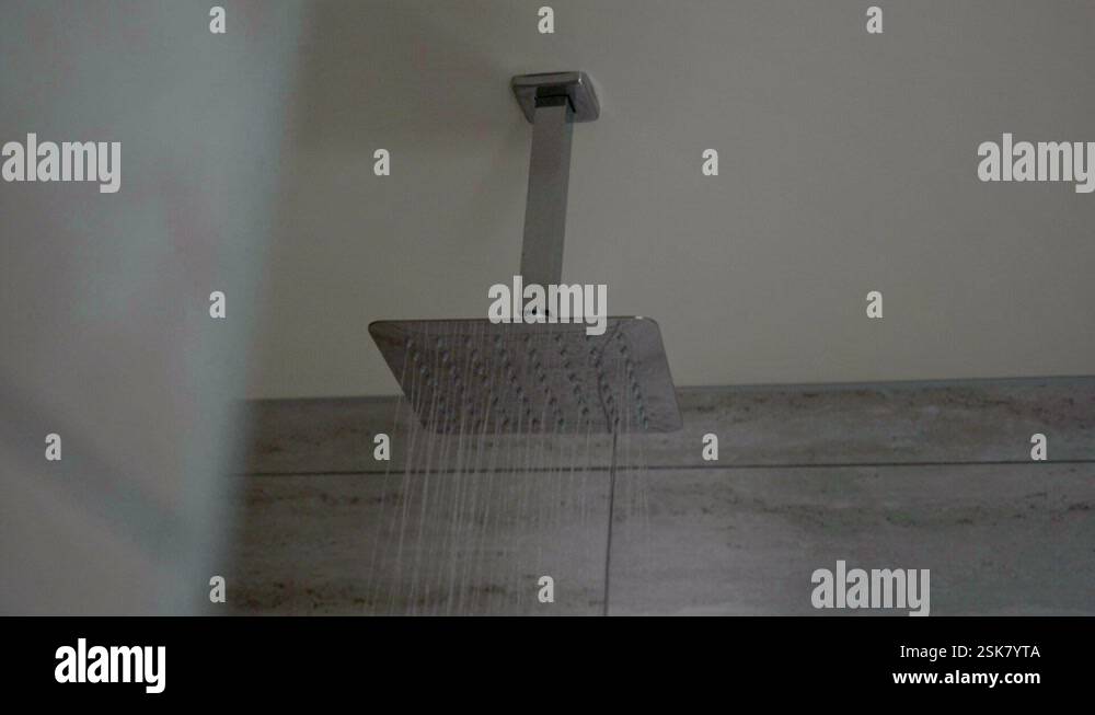 Large, square shower head on white ceiling; sliding reveal Stock Video ...