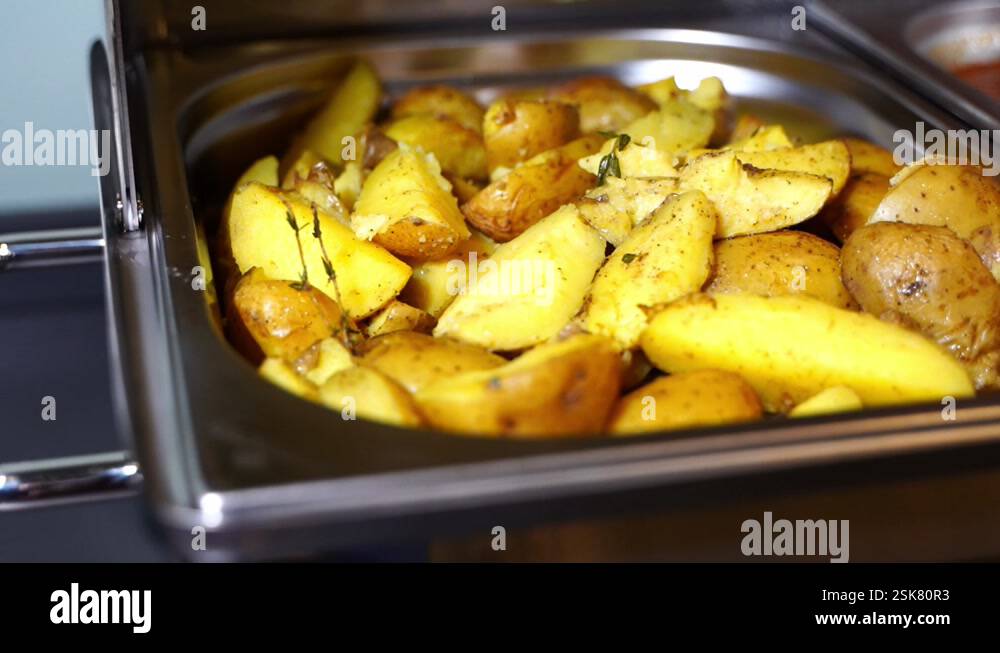 delicious baked potatoes in a buffet in a metal bowl at an event Stock ...