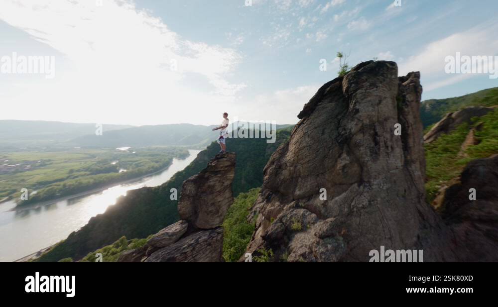 guy on top of mountain ridge, fast drone FPV, speed aerial shot, king ...